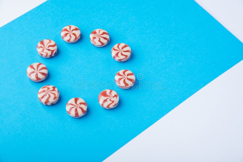 Round Candy Red and White on a Blue Background Stock Photo - Image of ...