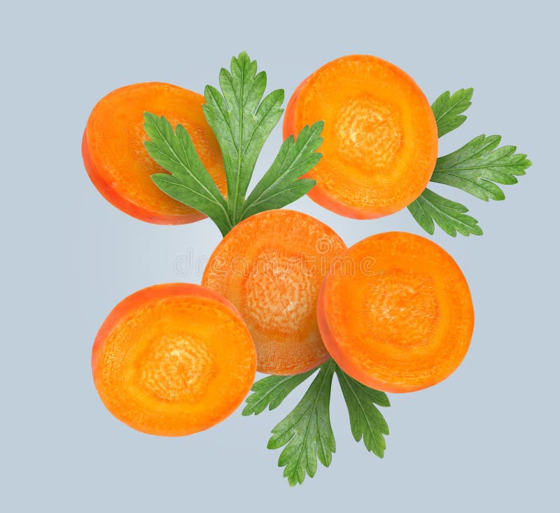 Round Carrot Slices and Parsley in Air on Grey Background Stock Photo ...