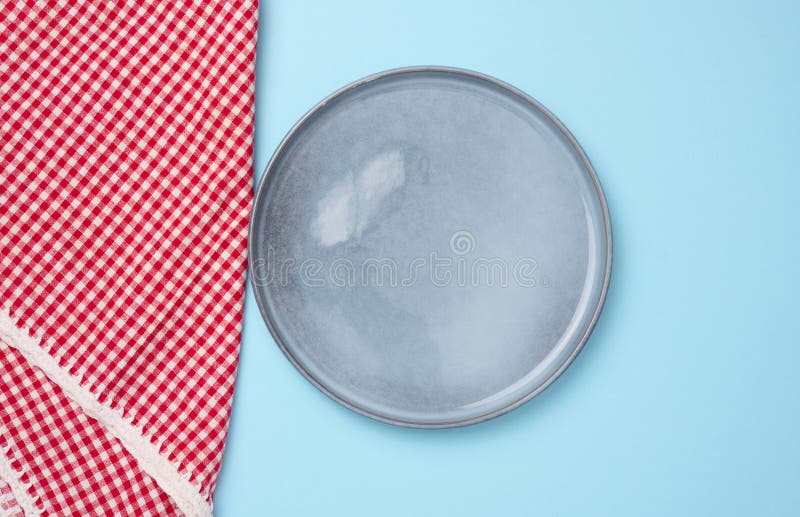 Round Ceramic Empty Blue Plate and Red Kitchen Towel Stock Photo ...