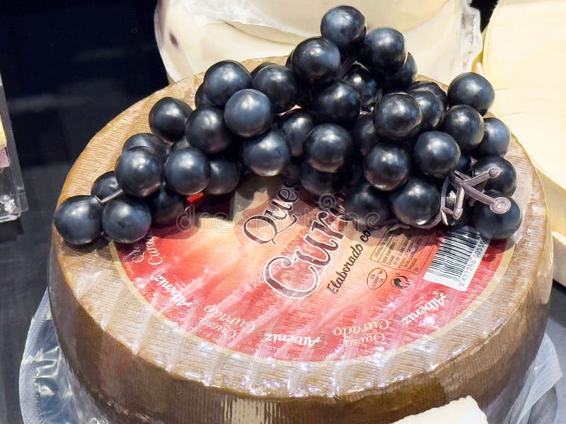 Round Cheese Wheel with Fresh Black Grapes on Top Editorial Stock Photo ...