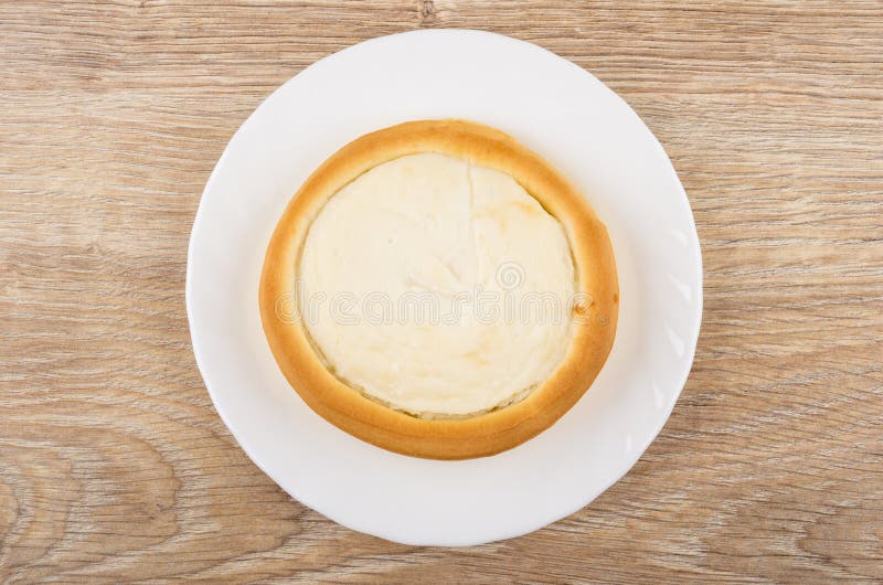 Round Cheesecake in White Plate on Wooden Table Stock Photo - Image of ...