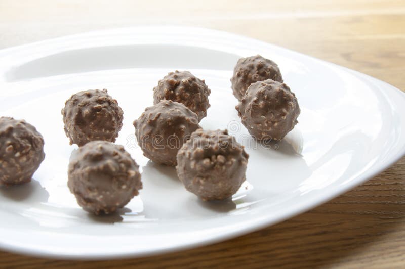 Round Chocolate with Nuts on a White Plate Stock Photo - Image of ...