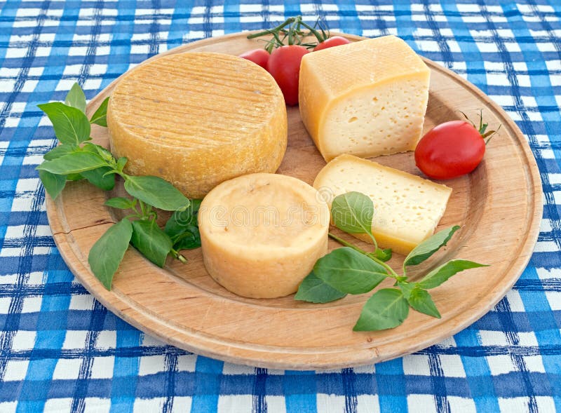 Round, Circular Cheeseboard with Cheese on Blue Tablecloth. Stock Image ...