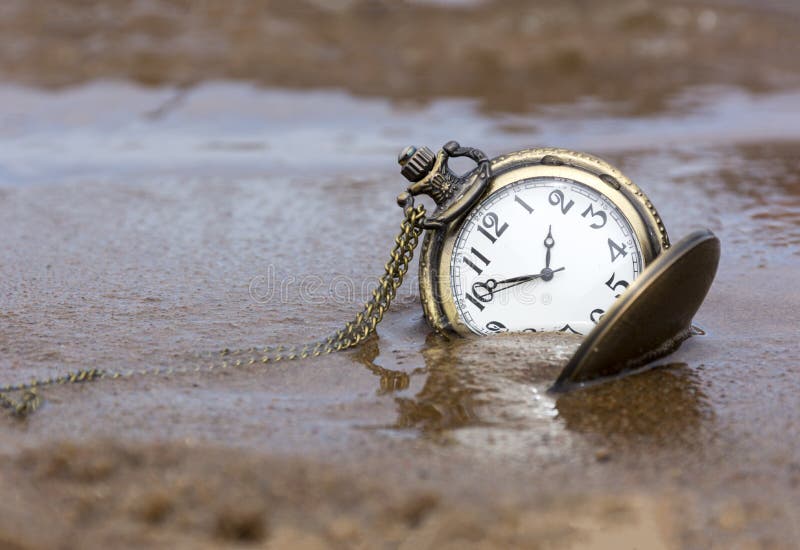 Round Clock with Hands Lying on the Wet Sand, Water, Time Stock Photo ...