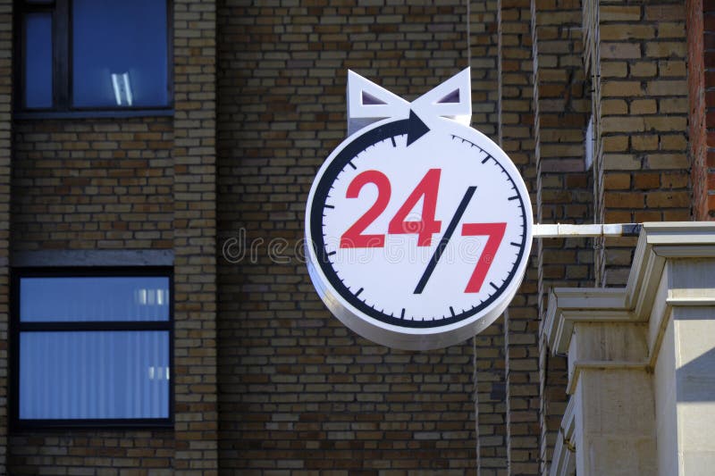 Round the Clock Sign Facade Brick House. Stock Image - Image of ...