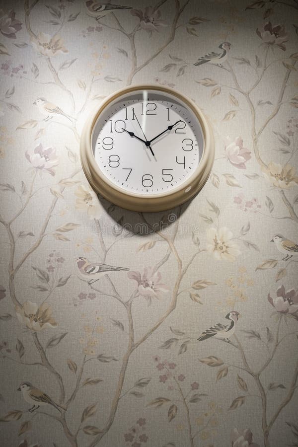 A Round Clock on the Wall Indicates the Exact Time. Decor in the Room ...
