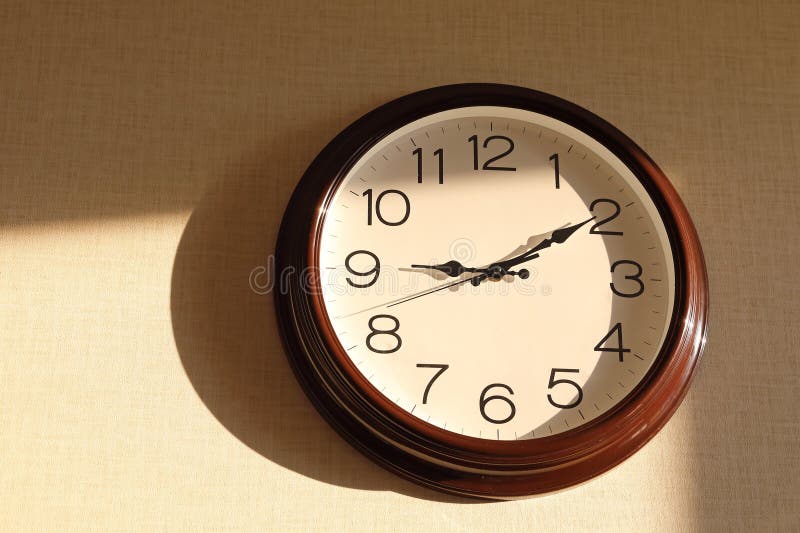 Round Clock with a White Dial on the Wall Stock Image - Image of clock ...