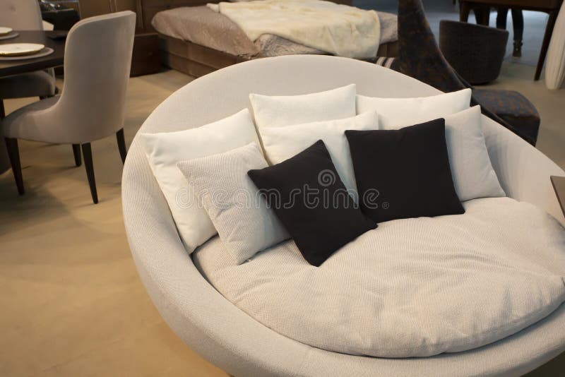 Round Comfortable Sofa with Black Pillows Stock Image - Image of black ...
