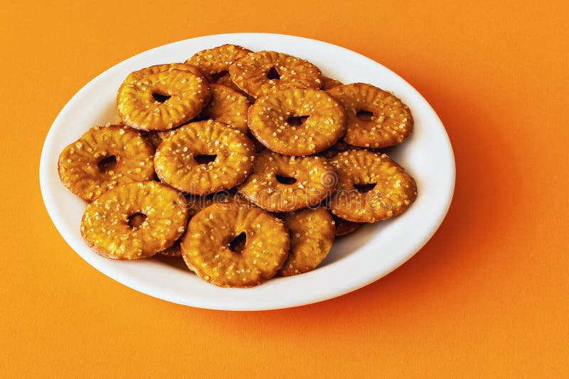 Round Crackers with a Hole and Salt on an Orange Background Stock Photo ...