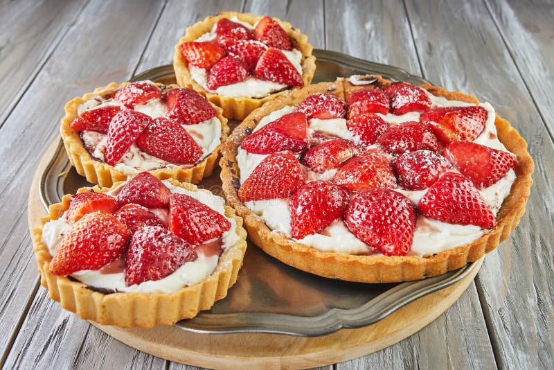 Round Cream Pie with Strawberries. One Big and Three Small Stock Photo ...