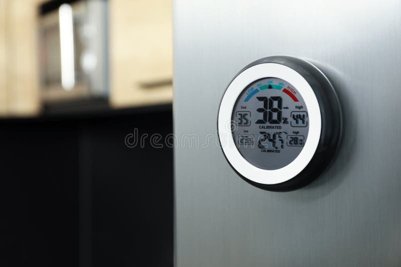 Round Digital Hygrometer with Thermometer on Fridge in Kitchen. Space ...