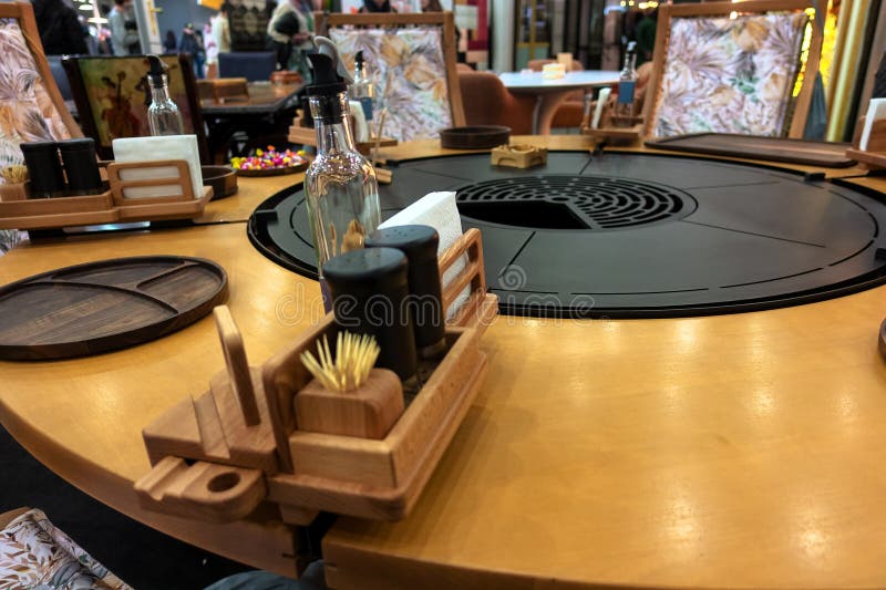 Round Dining Table with Round Grill Inside Stock Image - Image of ...