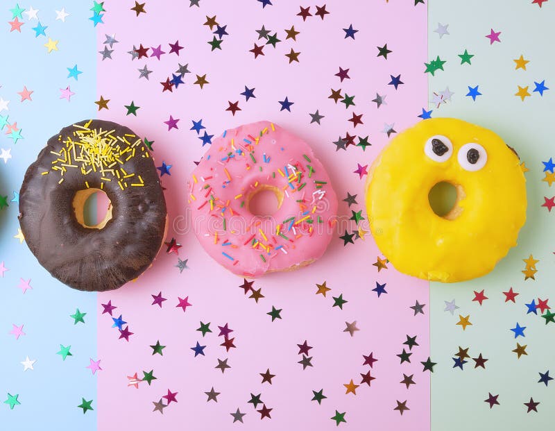 Round Donuts with Various Fillings and Sprinkles on an Abstract Color ...