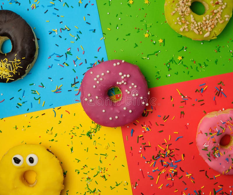 Round Donuts with Various Fillings and Sprinkles on an Abstract Color ...