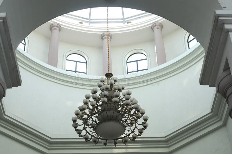 A Round Drop Light with a Golden Chain Hanging on a Glass Dome Stock ...