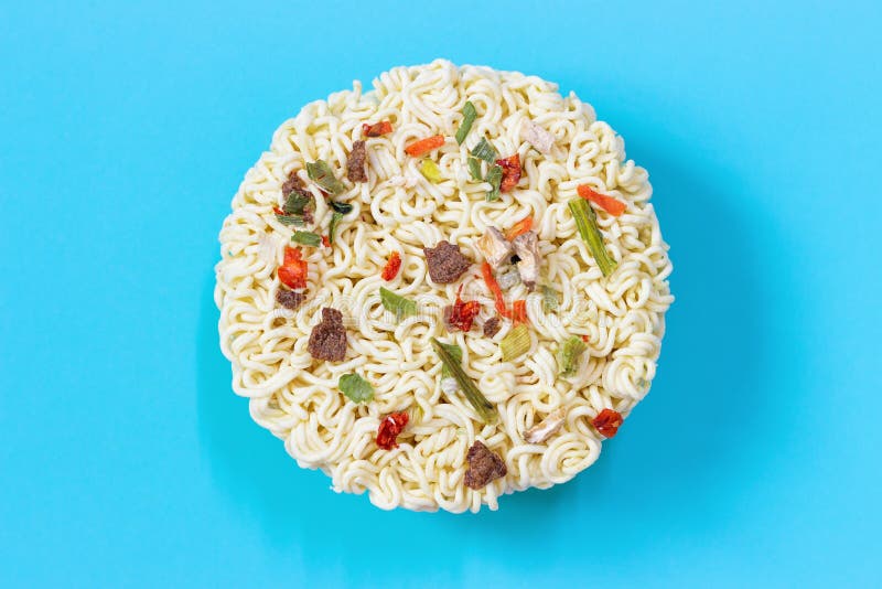 Round Dry Instant Noodles with Spices on Blue Background, View from ...