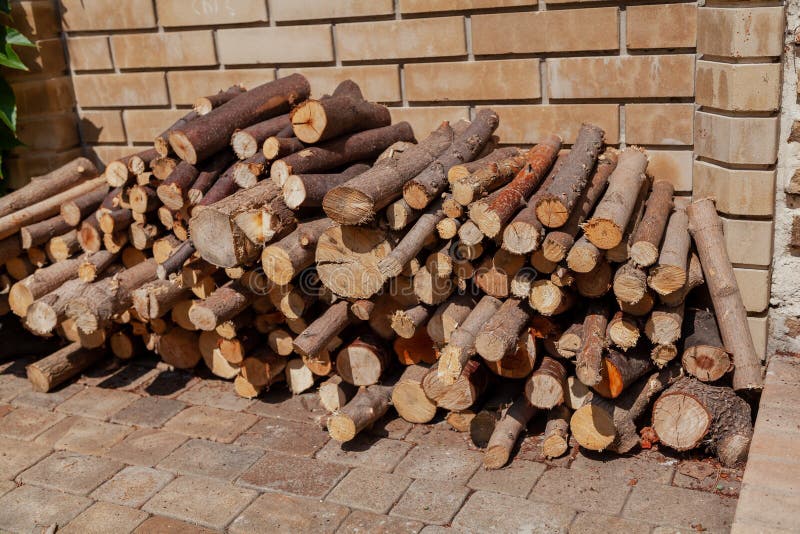 Round Firewood Stacked in Front of Brick Fence Stock Image - Image of ...
