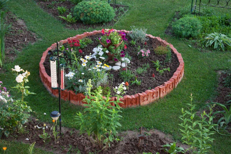 Round Flower Bed in the Garden Stock Photo - Image of gardening, grass ...