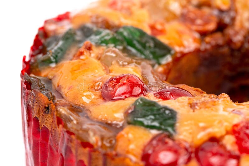 A Round Fruit Cake with Cherries Pineapples and Nuts on a White ...