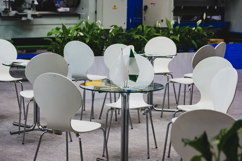Round Glass Conference Table with White Chairs. There is an Antiseptic ...
