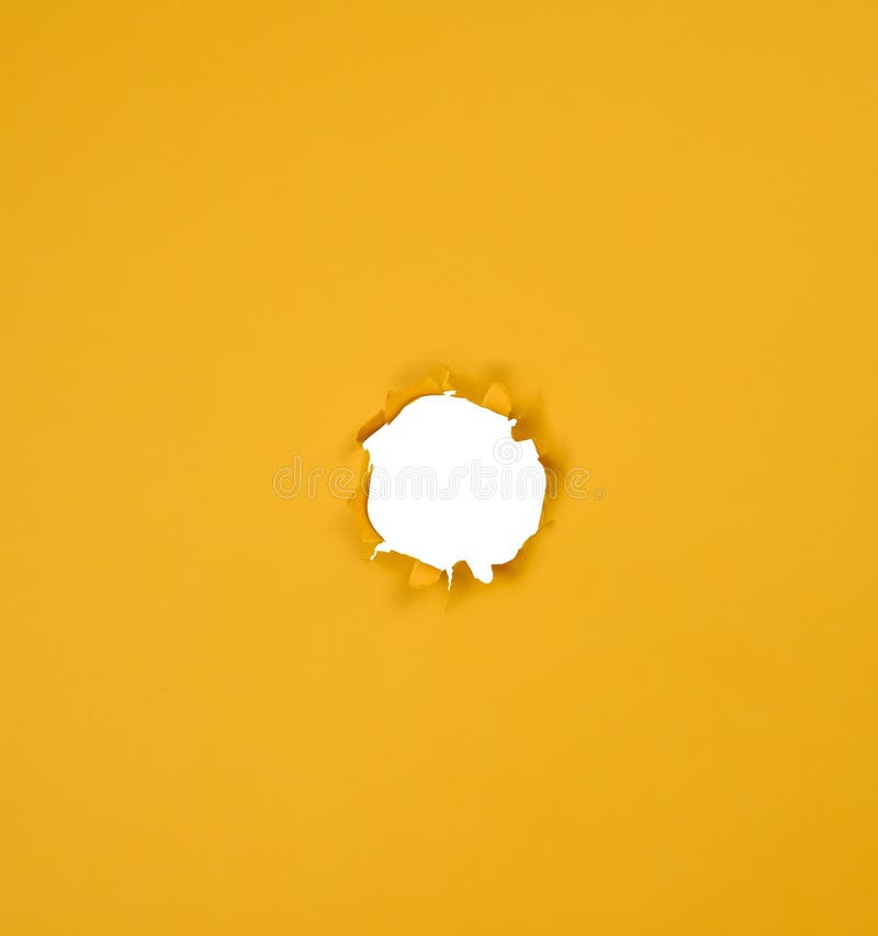 A Round Hole with Jagged Edges is Made in a Sheet of Bright Yellow ...