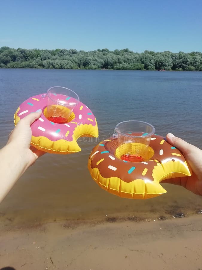 Round Inflatable Circles in the Form of a Donut in the Hands of Two ...
