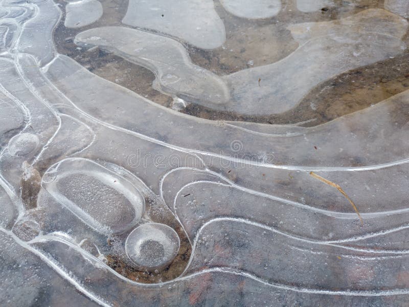 Round Irregular Shapes in Ice on Frozen Puddle in Winter, Concept of ...