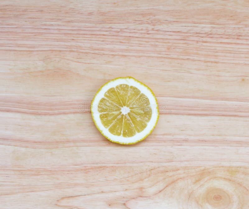 A Round Lemon Slice on Wooden Table Stock Photo - Image of tropical ...