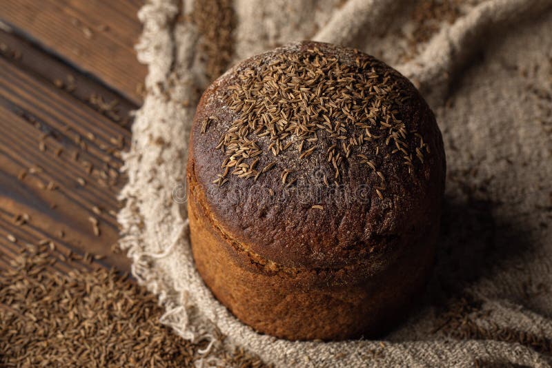 Round Loaf of Rye Bread with Thyme on Rustic Style Wooden Table. Stock ...