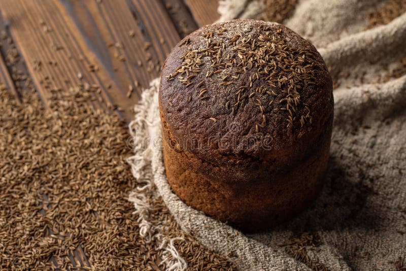 Round Loaf of Rye Bread with Thyme on Rustic Style Wooden Table. Stock ...
