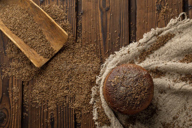 Round Loaf of Rye Bread with Thyme on Rustic Style Wooden Table Top ...