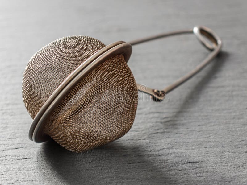 Round Metal Tea Strainer for Brewing Tea on a Black Background Stock ...