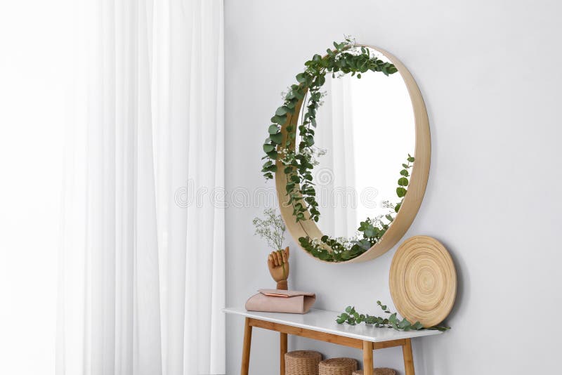 Round Mirror and Table with Accessories Near Wall. Modern Interior ...