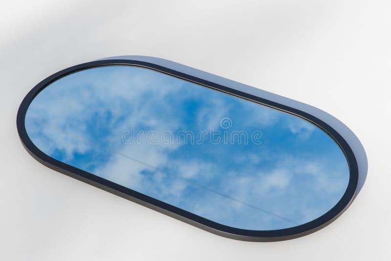 A Round or Oval Mirror with a Reflection of the Blue Sky and White ...