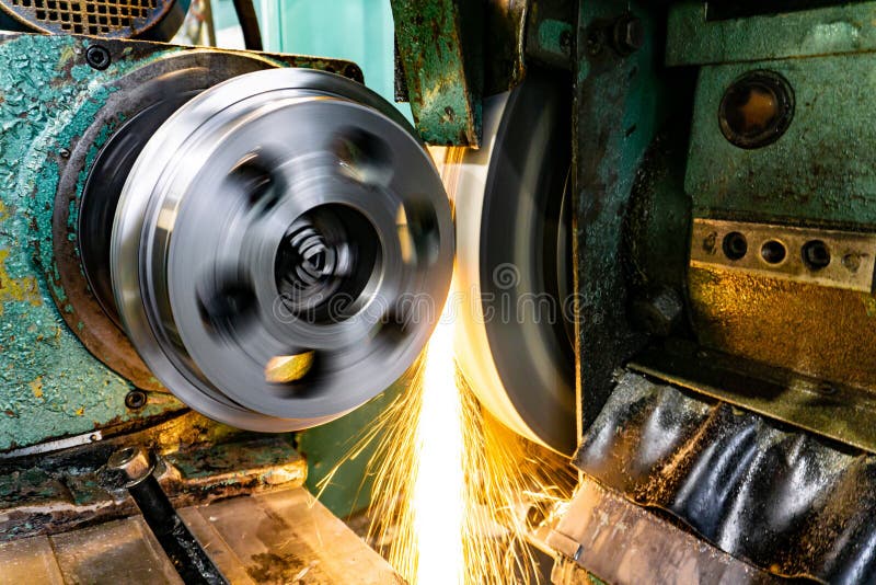 A round part with holes is ground on a machine, A round part with holes ...