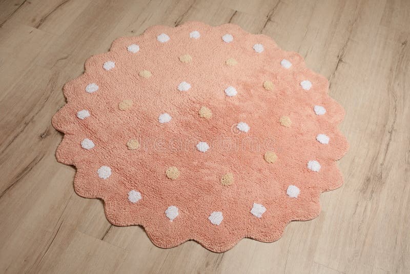 Round Pink Rug with Polka Dot Pattern on Wooden Floor Stock Photo ...
