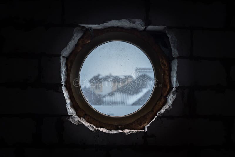 Round Plastic Window in a Bunker with Bare Walls in the Dark ...