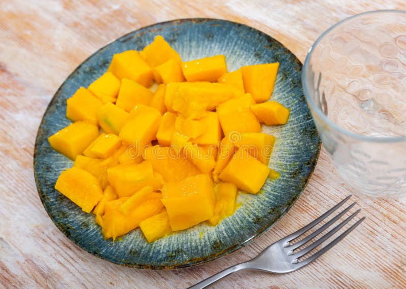On Round Plate with Blue Border - Pieces of Cubed Ripe Peeled Mango ...