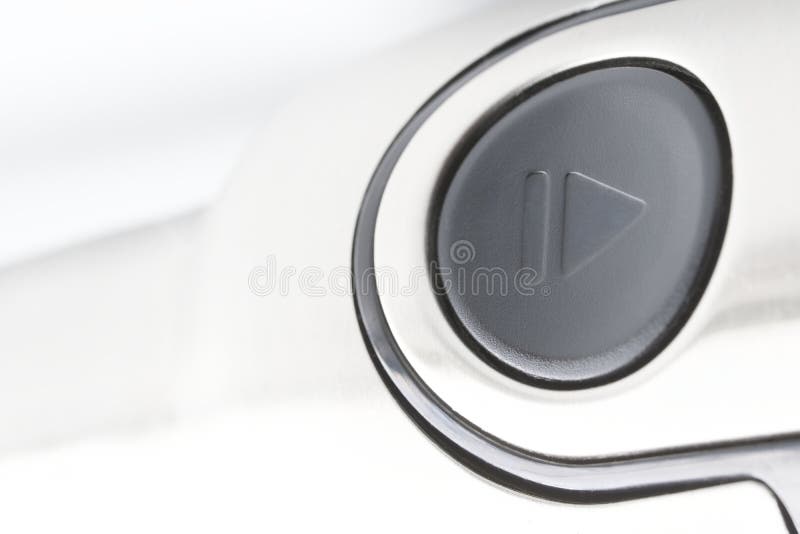 Round Play and Pause Button on a Light Polished Metal Surface of a ...