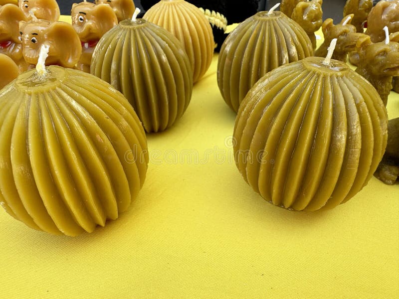 Round Ribbed Handmade Beeswax Candles on Yellow Background Stock Image ...