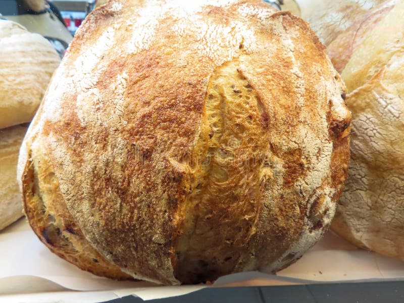 Round Rustic Sourdough Bread Loaf with Crispy Crust and Flour-dusted ...