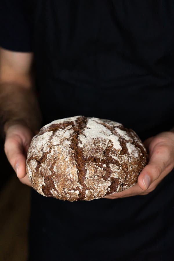 Round Rye Bread in the Hands of Men. Baker and Hot Baked Goods. Stock ...