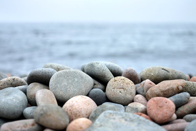 Round Sea Stones in Front of Water Stock Photo - Image of texture ...