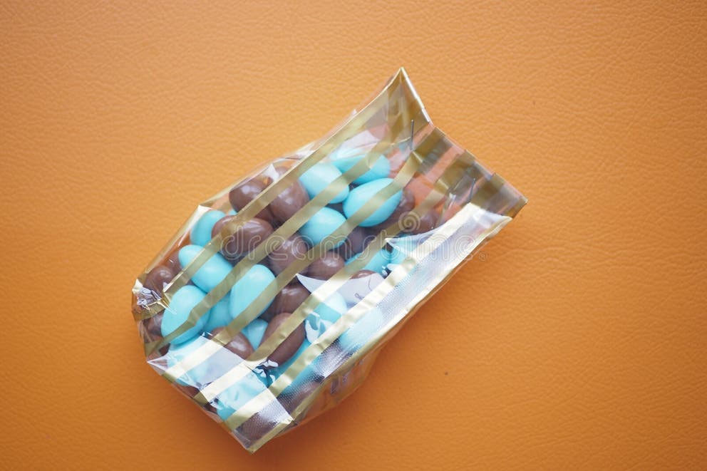 Round Shape Chocolate Candy in Blue and Brown Color in a Plastic Packet ...