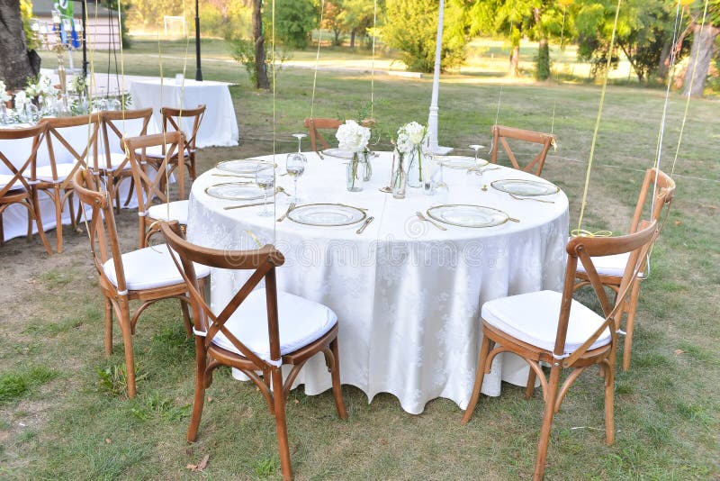 Round-shaped Table with a White Tablecloth Decorated with Table ...