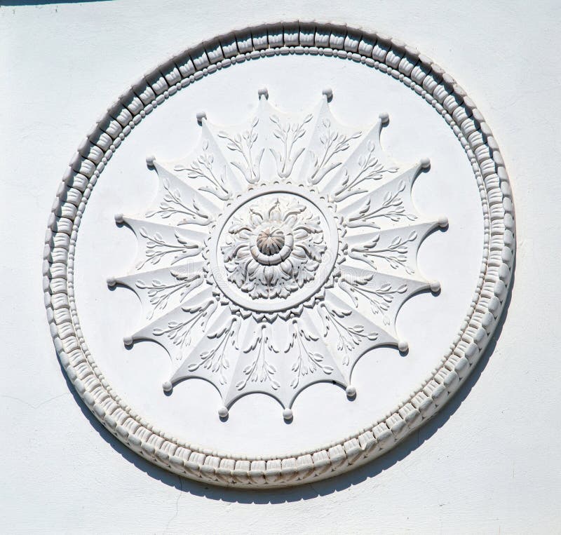 A Round-shaped White Plaster Rosette with a Ring and Diverging Rays and ...