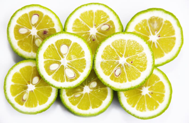 Round Slices of Natural Lime Lemon with Seeds on a White Background ...