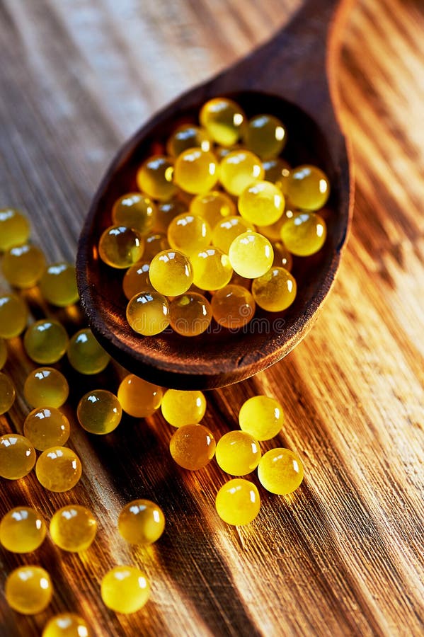 Round Small Fish Oil Capsules on Wooden Spoon Scattered a Surface Stock ...