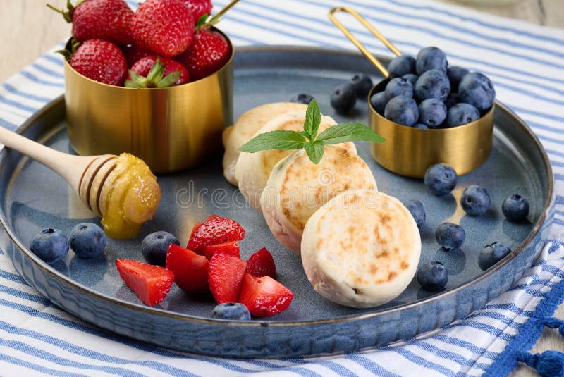 Round Small Fried Cheesecakes on a Blue Plate with Berries. Healthy ...