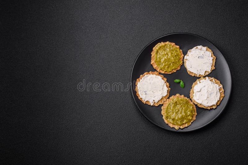 Round Snacks with Crispy Chips or Crackers with Cream Cheese and Pesto ...